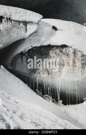 A mesmerizing view of jagged snowy mountains under dark clouds Stock ...
