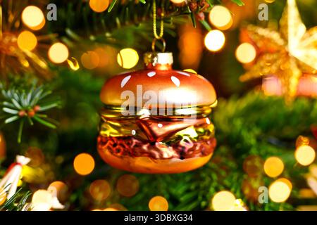 Christmas bauble in the shape of a hamburger hanging on a Christmas ...