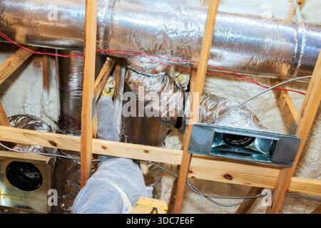 Workers are building wooden frame with ductwork in new construction ...