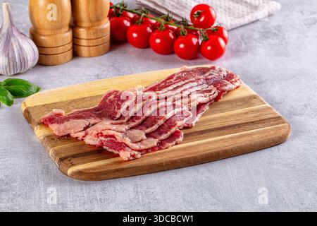 Raw beef marble bacon slices over board Stock Photo - Alamy