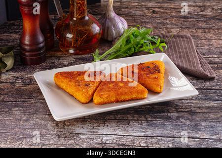 Fried golden fish cutlets triangles in the plate Stock Photo - Alamy