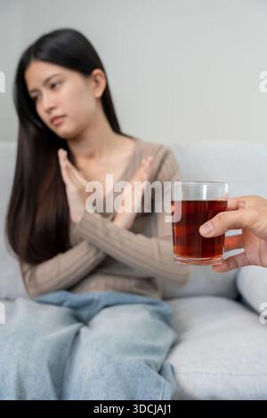 woman refuses say no and avoid to drink an alcohol whiskey, stopping ...