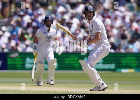 England's Zak Crawley, left, bats in front of Australia's Alex Carey on ...