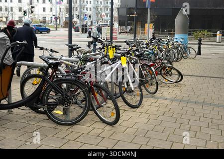 Double-decker bicycle parking with various bicycles in an urban ...