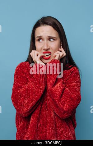 A woman gestures with her hand near her face while smiling Stock Photo ...