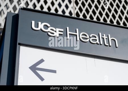 Directional sign with UCSF Health logo and arrow against blue sky, San ...