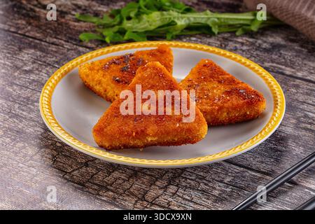 Fried golden fish cutlets triangles in the plate Stock Photo - Alamy