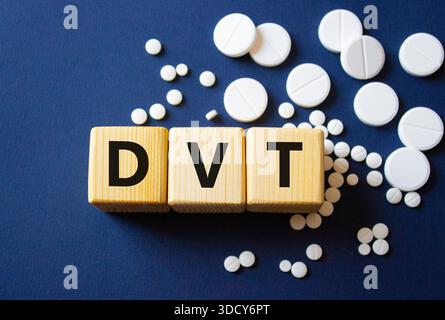 DVT symbol. Wooden cubes with words DVT Deep vein thrombosis. Beautiful ...
