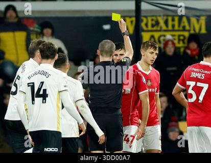 Referee Andrew Kitchen shows a yellow card to Zak Sturge of Millwall ...