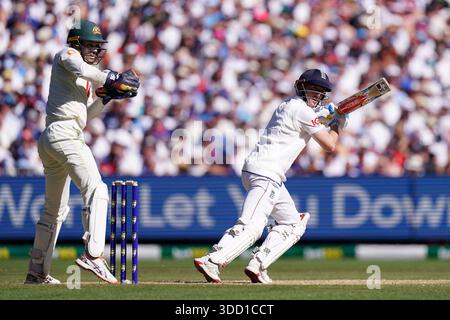 England's Harry Brook bats as Australia's Alex Carey watches during ...