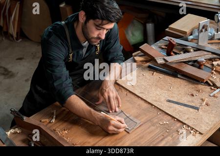 Wood artisan tracing design pattern on timber, crafting custom wooden ...