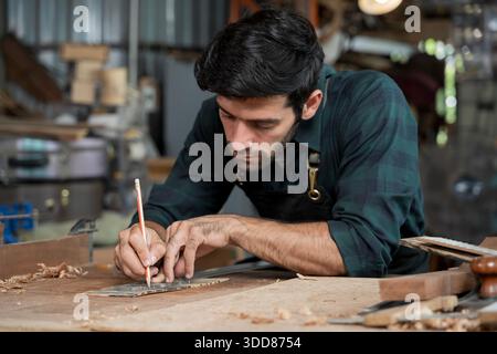 Wood artisan tracing design pattern on timber, crafting custom wooden ...