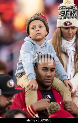 A fan watches Chicago Bears players at the NFL football team's practice ...