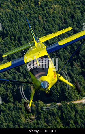 Single engine propeller plane maneuvering at low altitude close to the ...