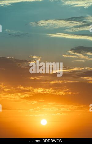 Bright orange sunrise of the sun disk in the snowy mountains. Marmarosy ...