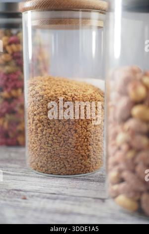 Different types of nuts, seeds and dried fruits on black background ...