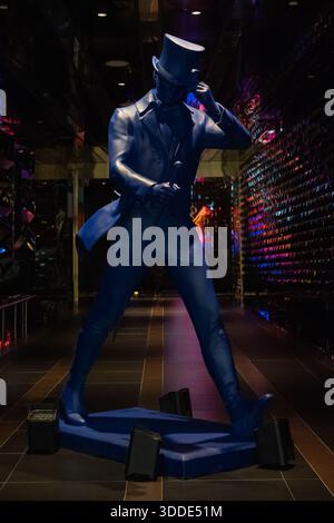 Blue performer statue in dramatic pose with hat and cane Stock Photo ...