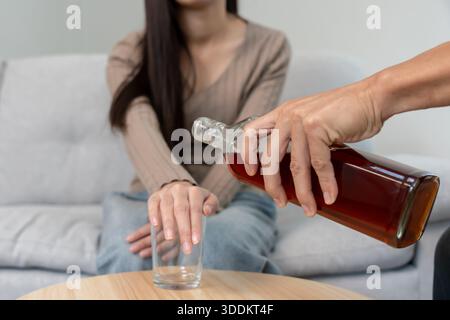 woman refuses say no and avoid to drink an alcohol whiskey, stopping ...