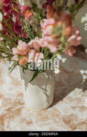 Blooming flowers in a marble vase in garden Stock Photo - Alamy
