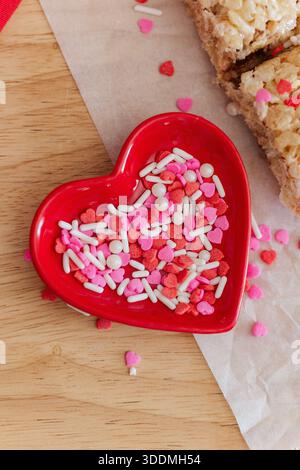 Valentines Day candy heart sprinkles corner border over a white marble ...