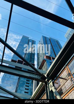 Low angle view of sleek glass building exterior with dark metal grid ...