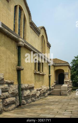Historic European style church tower with green spire and yellow walls ...