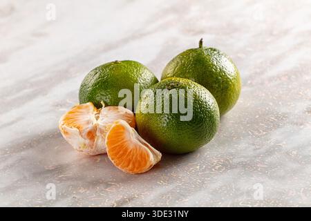 Sweet green juicy tangerin heap fruit Stock Photo - Alamy