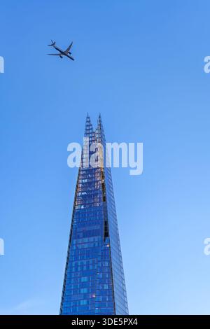 aeroplane flying over the skyscrapers. architecture building with ...