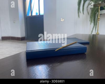 the rosary and new testament on the bench in old church Stock Photo - Alamy