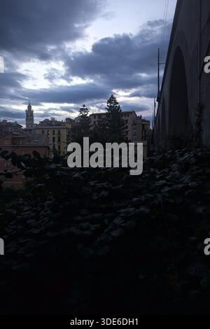 Town on a cliff at sunset framed by arches of a bridge Stock Photo - Alamy