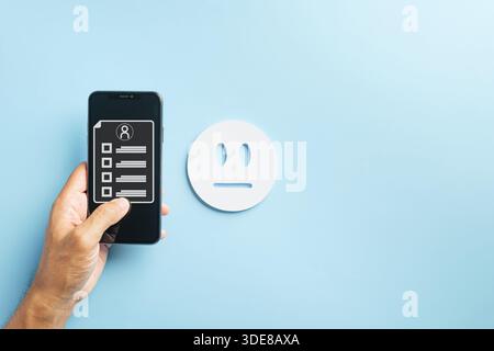Customer feedback survey displays neutral satisfaction rating, hand ...
