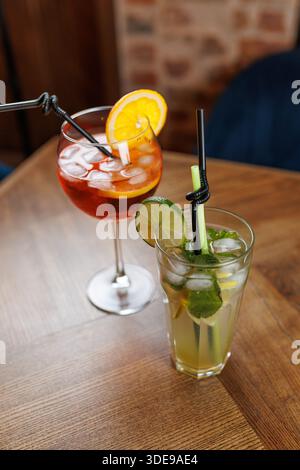Two colorful cocktails sit on a dark table Stock Photo - Alamy