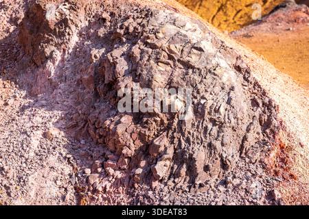 Eroded bauxite rock formation with bright orange colors in an abandoned ...