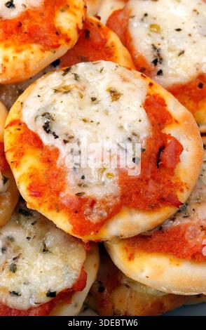 Different tasty mini pizzas on white background Stock Photo - Alamy