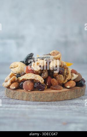 Nuts, raisins and apricots on rustic wooden background. Concept for ...