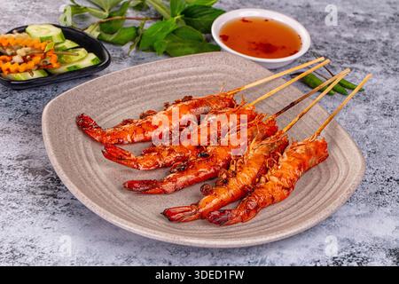 Grilled tiger prawn skewer served sauce Stock Photo - Alamy