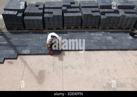 Construction of pavement and wooden pallets. Laying concrete paving ...