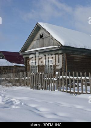 A Russian wood house covered in snow Stock Photo - Alamy