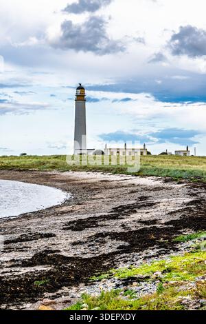 Aerial view of the Barns Ness Lighthouse coastline with morning sun ...