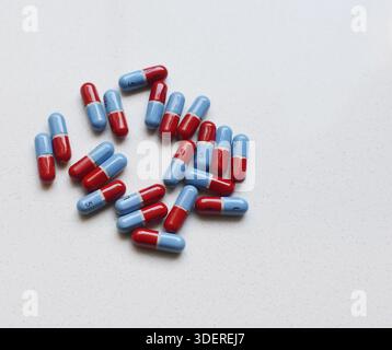 Close-up of pills scattered on the table, orange plastic medication ...
