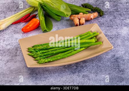Gourmet steamed green asparagus stems with olive oil Stock Photo - Alamy