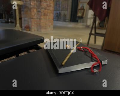 the rosary and new testament on the bench in old church Stock Photo - Alamy