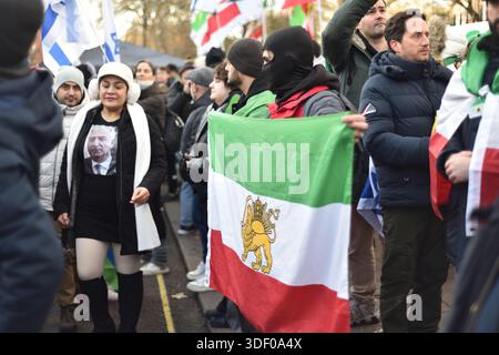 A pro-government Iranian protester holds up an anti-British placard in ...