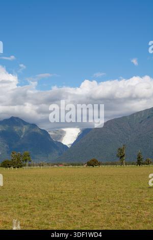 Open fields and majestic mountains in the background. Rural countryside ...