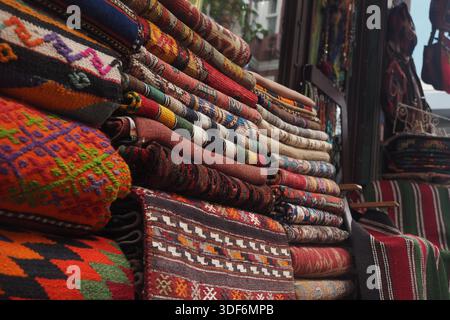 Stacked rugs in shop Stock Photo - Alamy
