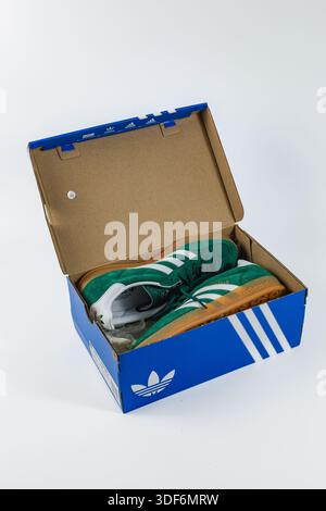 Cardboard box with blue sneakers on pink background Stock Photo - Alamy