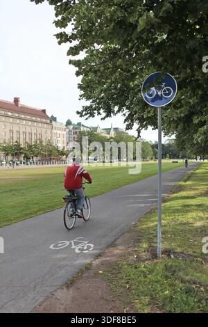 A cyclist rides along the road on a cloudy day. (Photo by Saqib Majeed ...