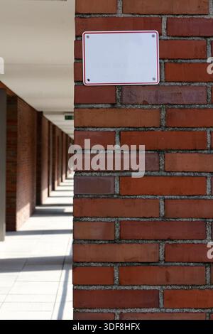 Empty red sign on a brick wall Stock Photo - Alamy