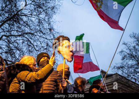 People carry Iranian flags and pro-government placards during a funeral ...