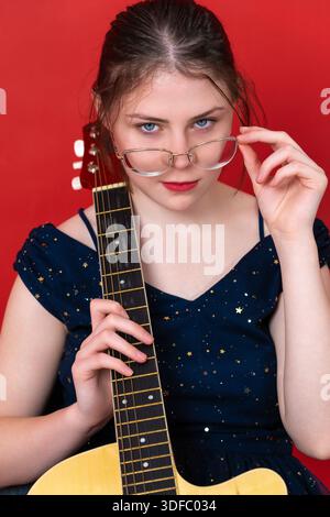 Portrait of female player in red mask who is targeting into enemies ...